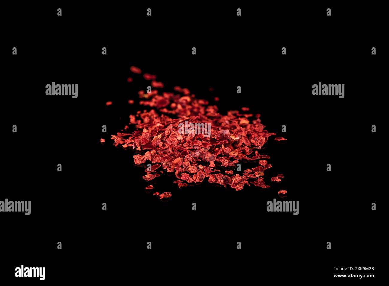 crushed dry red niora pepper isolated on black background Stock Photo ...