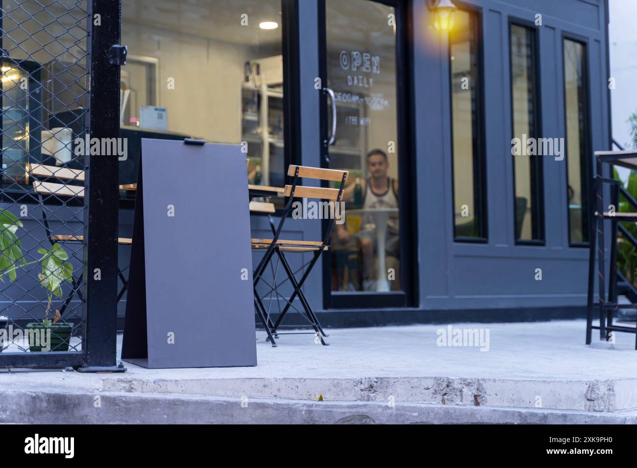 Empty black menu stand next to cafe entrance. Coffee shop and ...