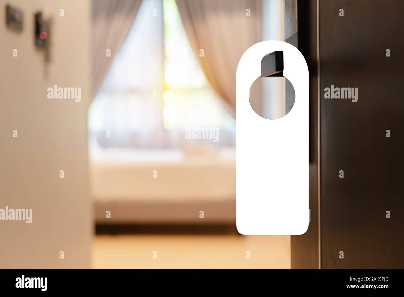 Entrance door of hotel room with empty sign please do not disturb. A ...