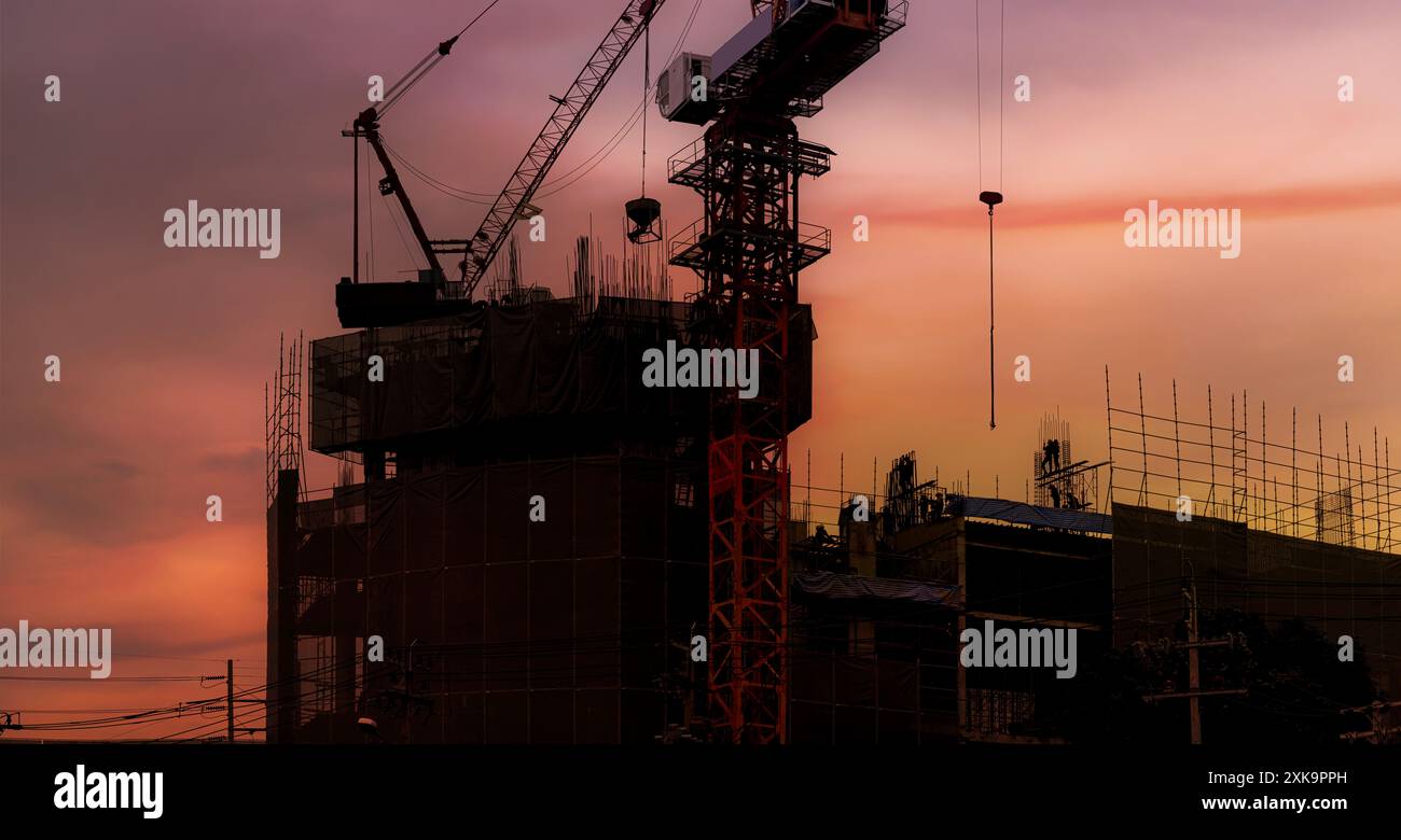New construction site with crane, machinery equipment on sunset ...