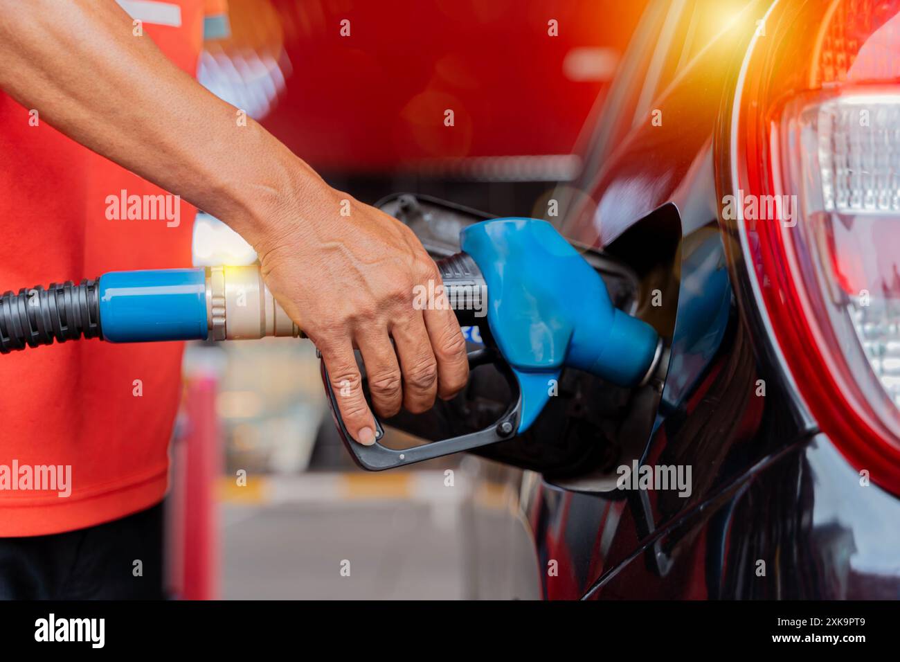 Refueling the car at a gas station fuel pump. Man driver hand refilling ...