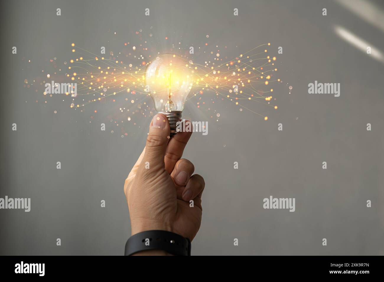 Hand holding glowing lightbulb with connection line for creative thinking idea and innovation ...