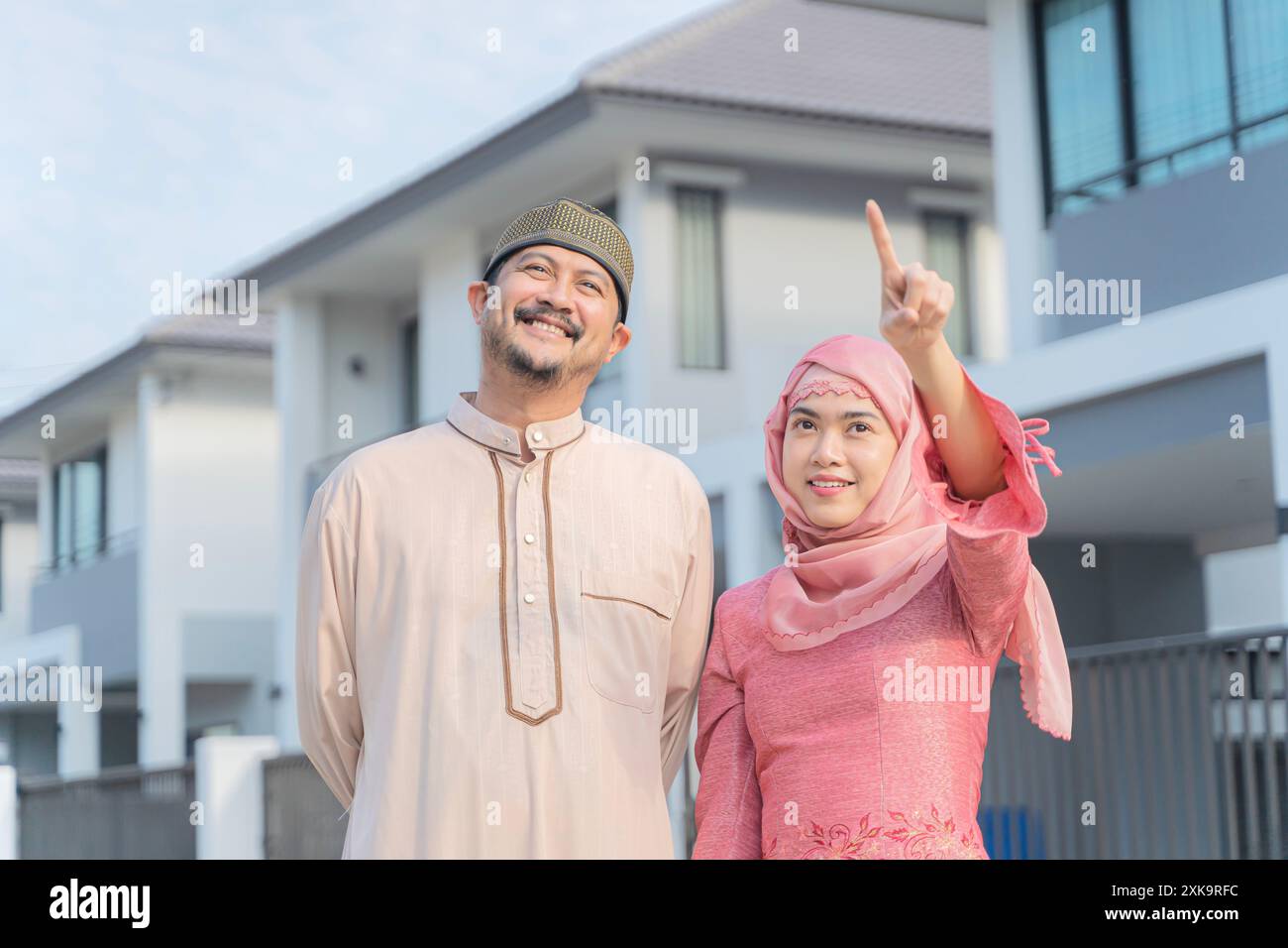 Loving young couple looking at dream house. Portrait of an excited ...