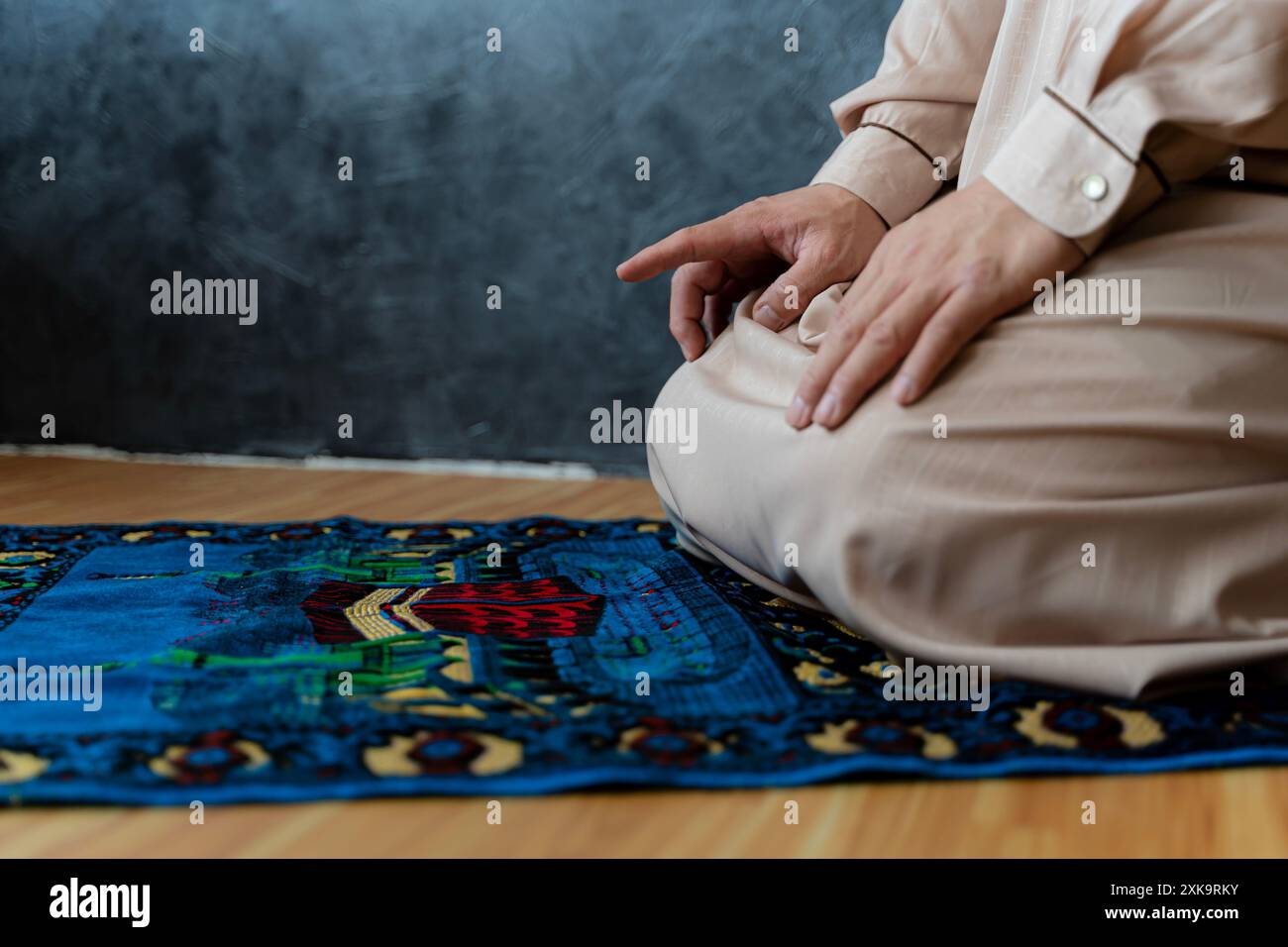 Muslim man praying indoors to god. Muslim men praying in Tashahhud ...