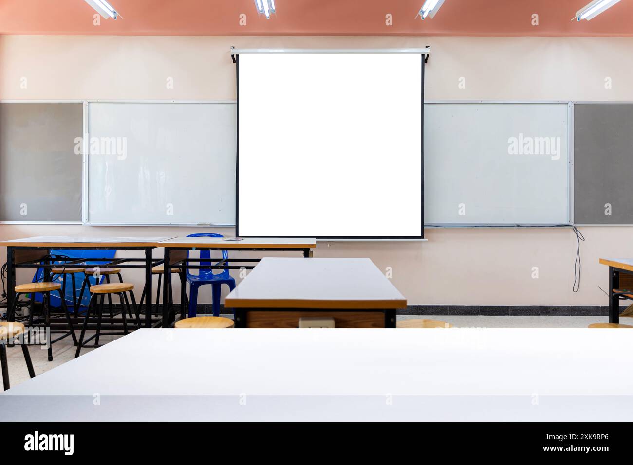 Projector screen canvas in modern conference room with big windows. Side view. Empty classroom ...
