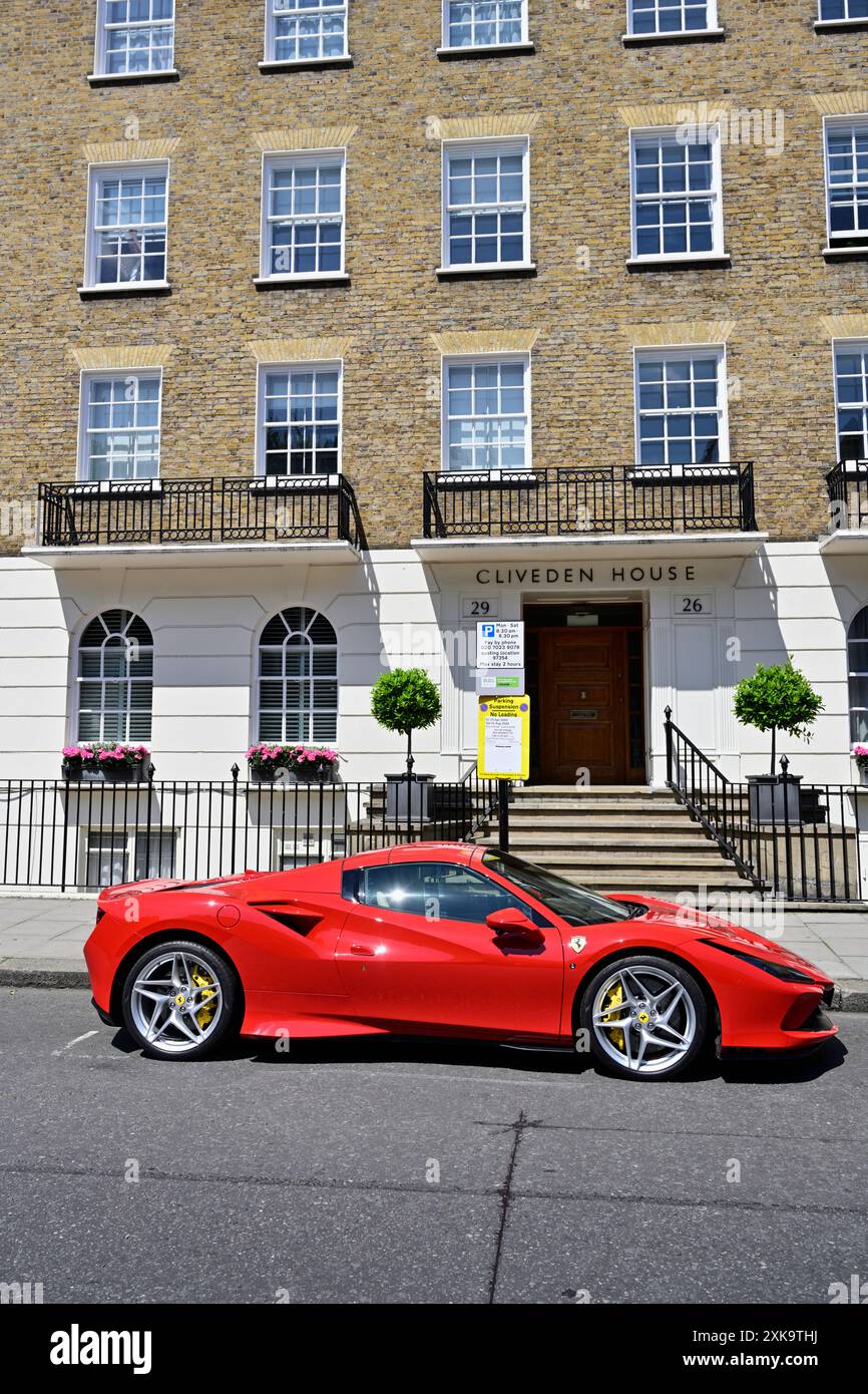 Red Ferrari sports car outside Cliveden House, Cliveden Place, Chelsea ...