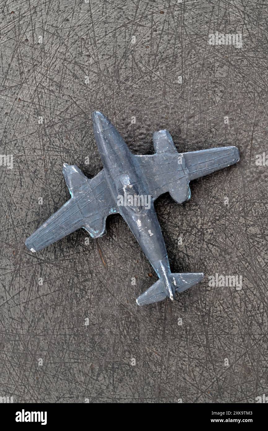 Vintage lead model of jet warplane lying on old pewter Stock Photo - Alamy