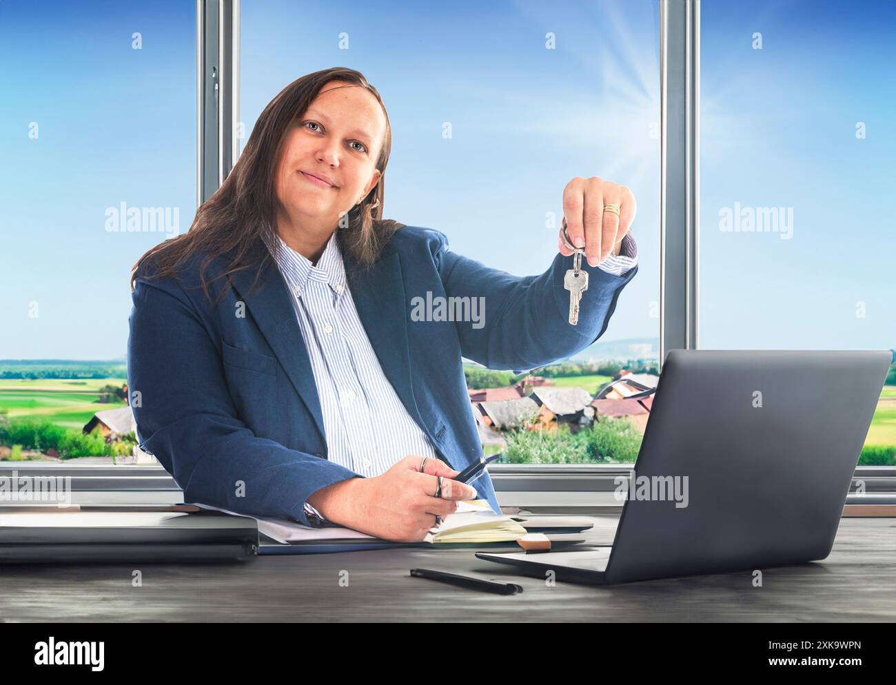 estate agent woman in front of window background Stock Photo - Alamy