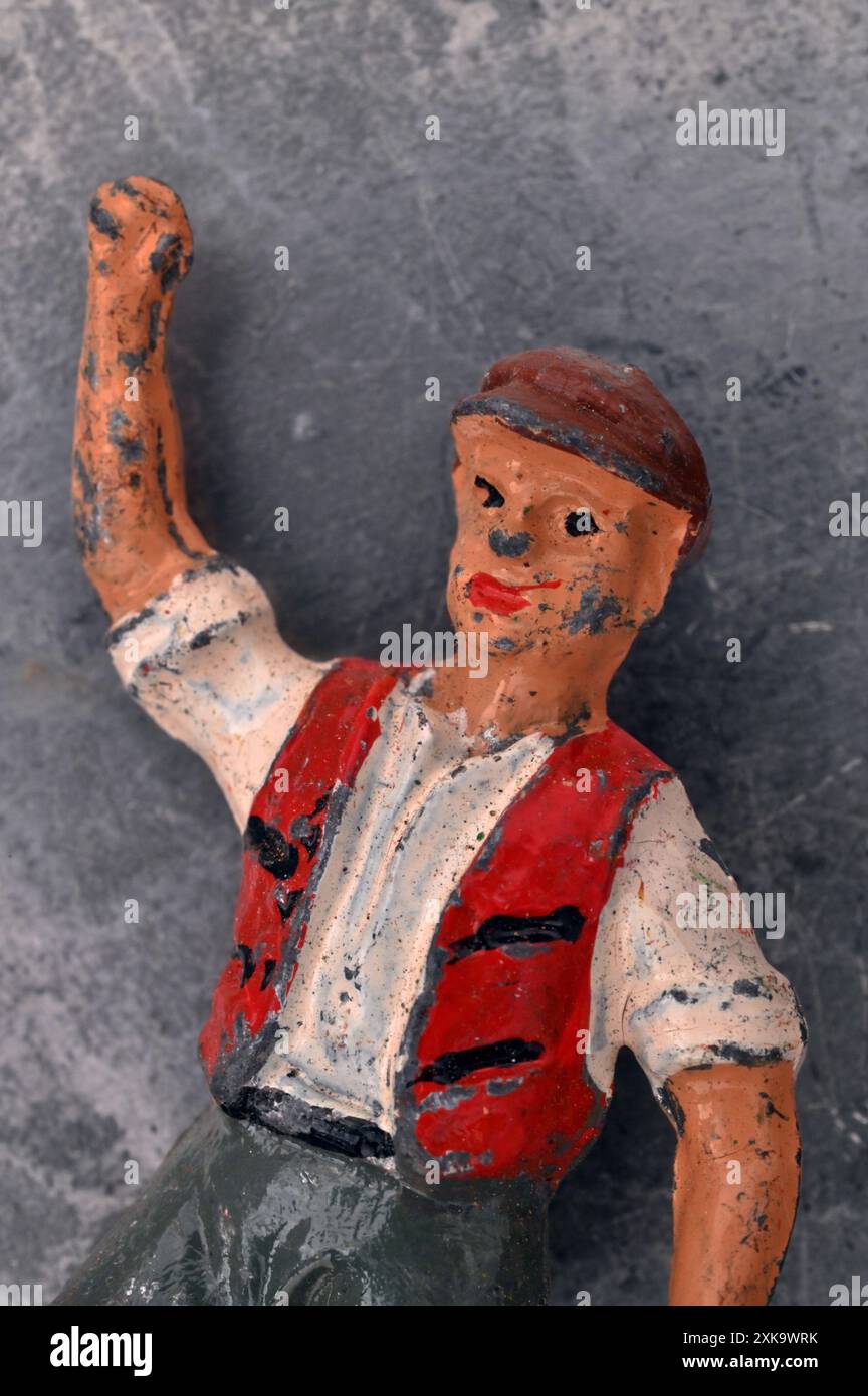 Vintage lead model of worker or labourer wearing cap and waistcoat with ...