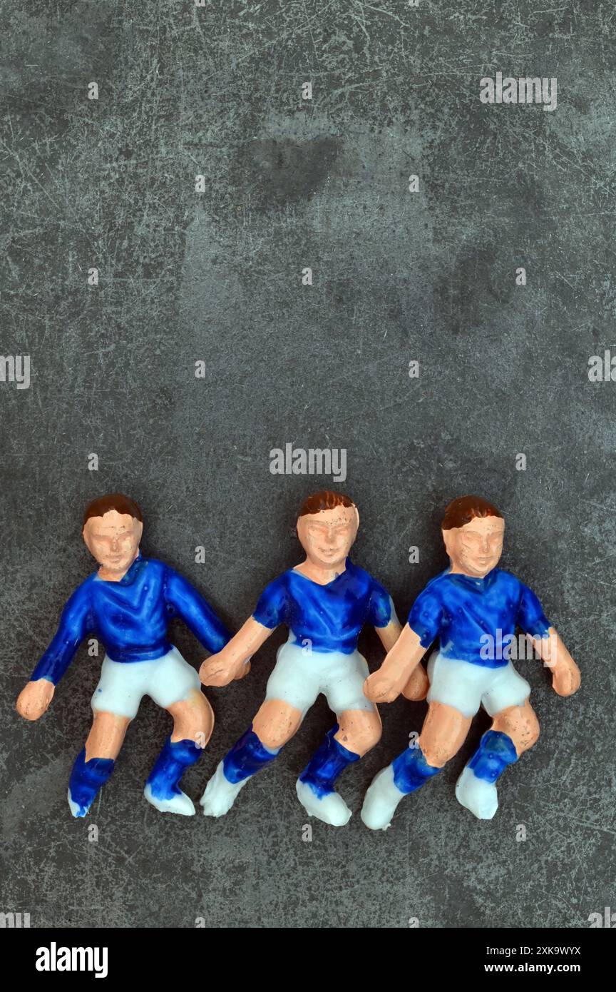 Vintage models of European football or soccer players lined up as if ...