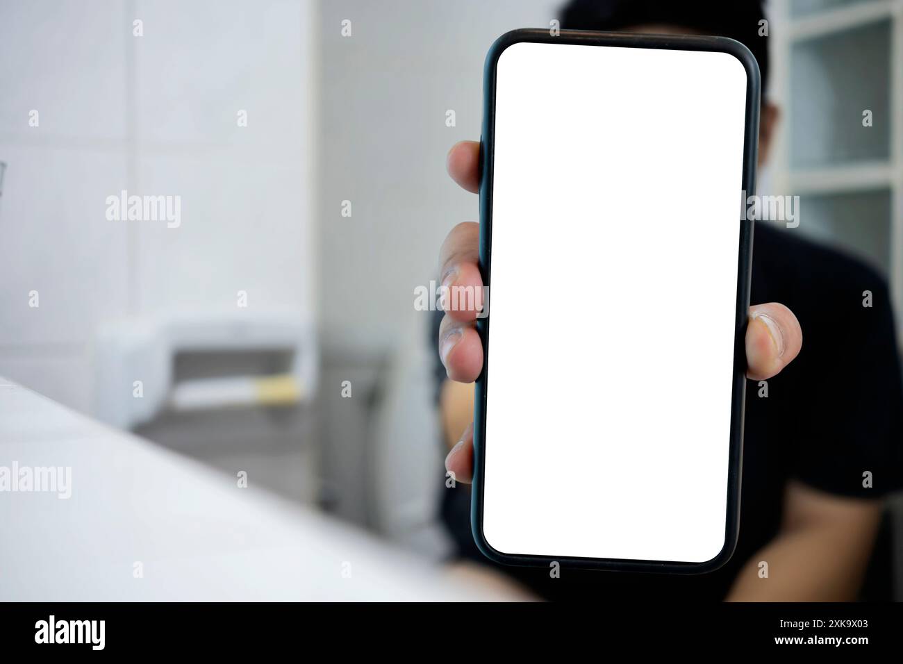 Smart phone with white screen background in toilet, restroom or WC ...
