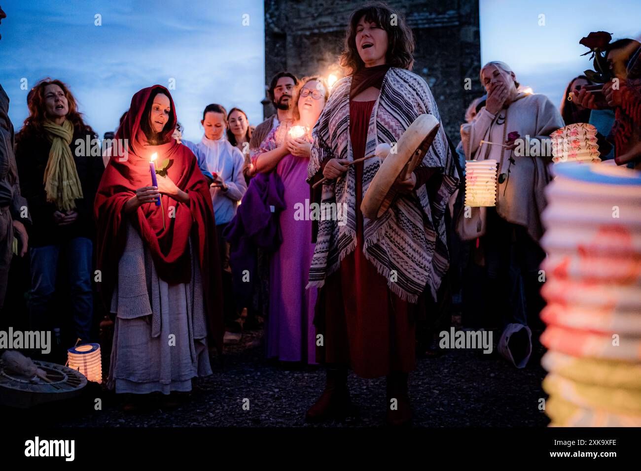 People sing and hold lanterns on the pilgrimage of light, during the Sacred Magdalene Festival ...