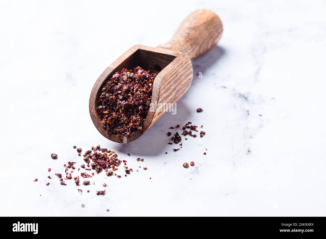 Dried red spice sumac in wooden spoon Stock Photo - Alamy