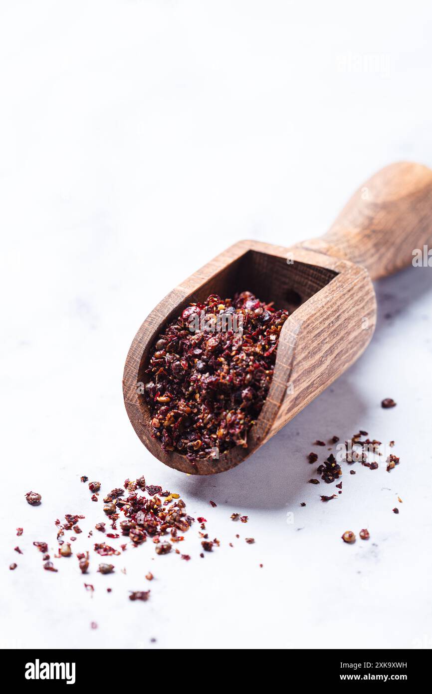 Dried red spice sumac in wooden spoon Stock Photo - Alamy
