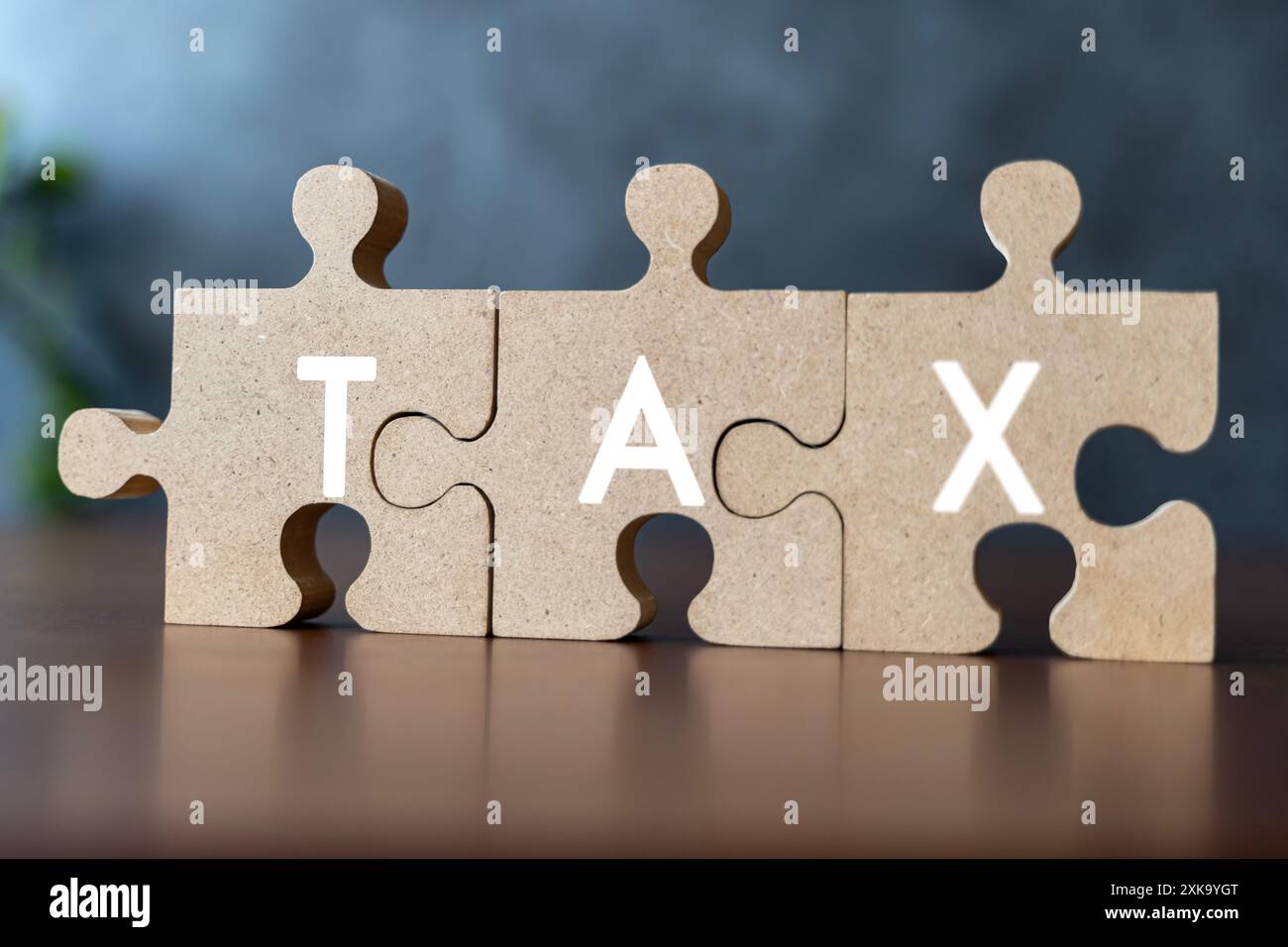 Taxes concept with wooden puzzle on a desk. Jigsaw puzzle as the task ...