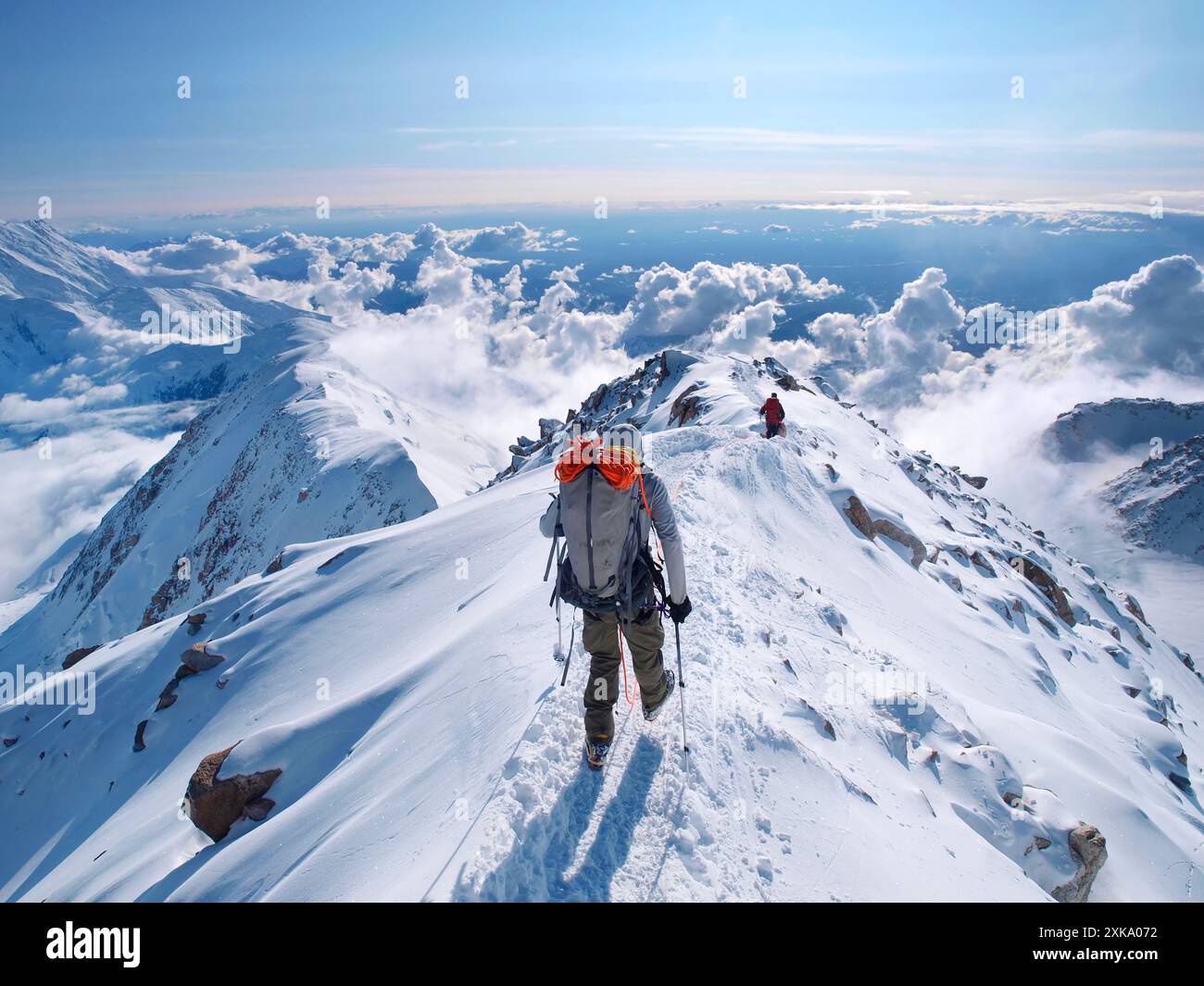 A mountain ranger is descending the Washburn ridge of Mount McKinley ...