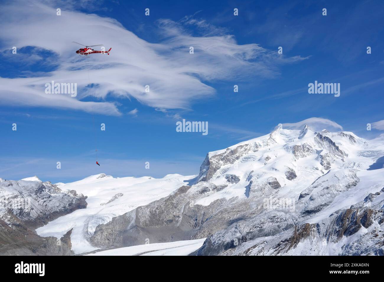 A rescue helicopter of mountain rescue company Air Zermatt performing a ...