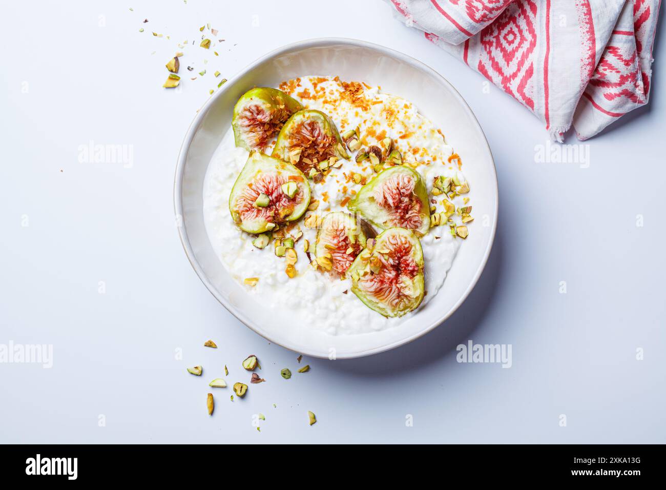 Breakfast cottage cheese with figs and maple syrup, white background ...