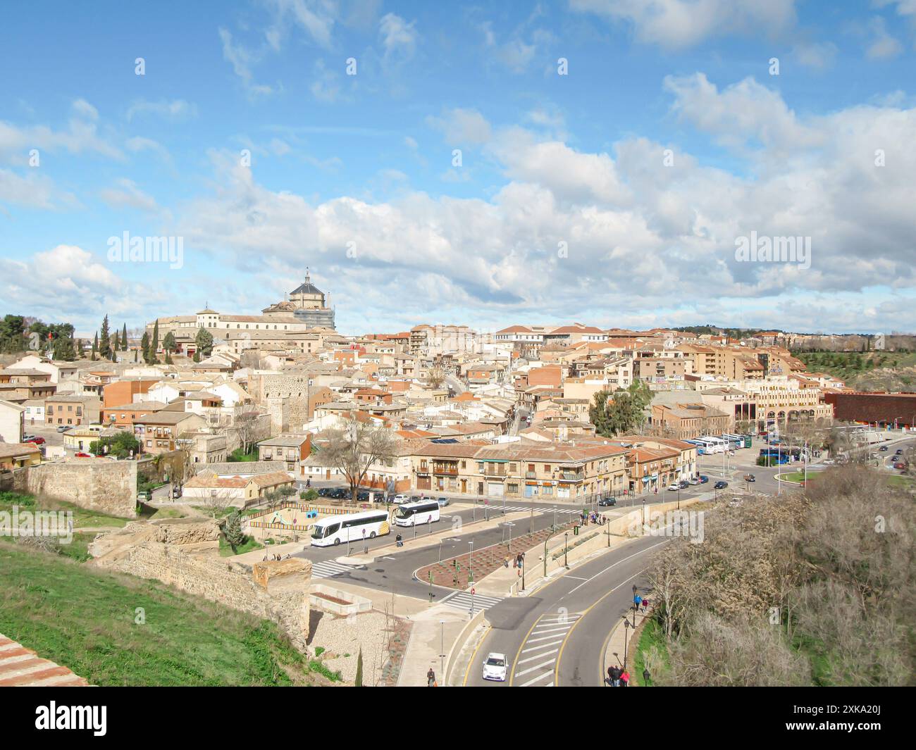Panorama of a Spanish city with historic buildings, roads, and buses ...