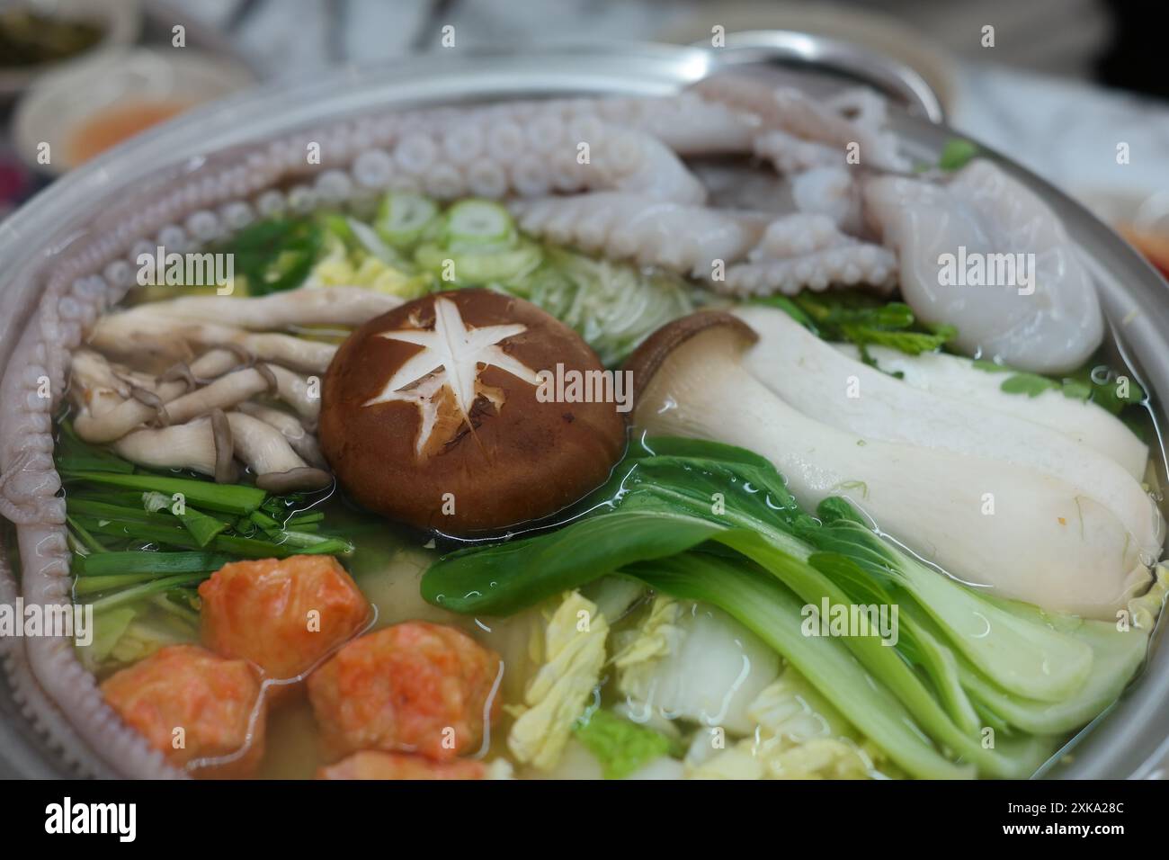 Korean style hot pot with octopus, mushrooms and vegetables Stock Photo ...