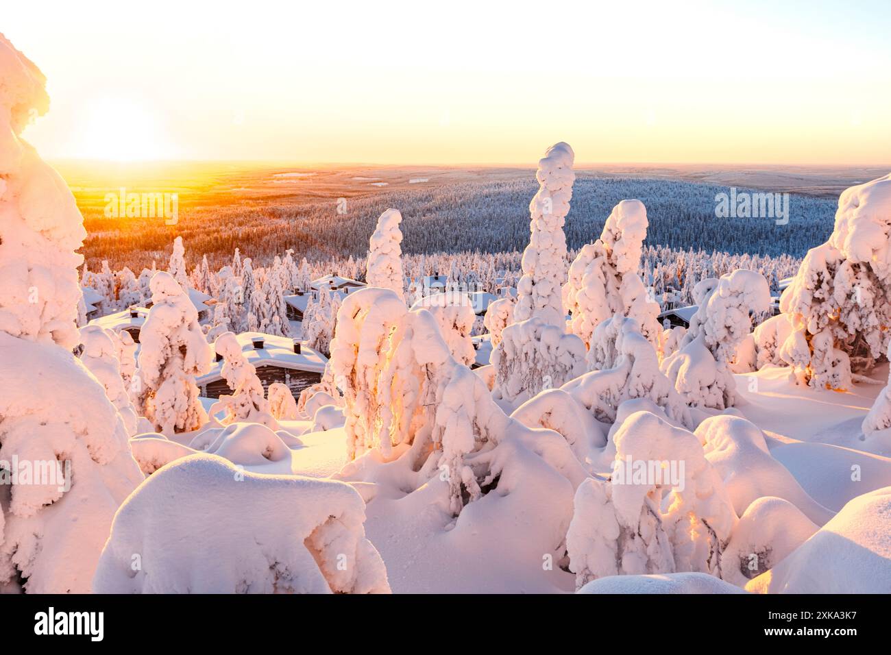 Snowy mountain huts in a frozen forest at dawn, Iso Syote, Finland ...