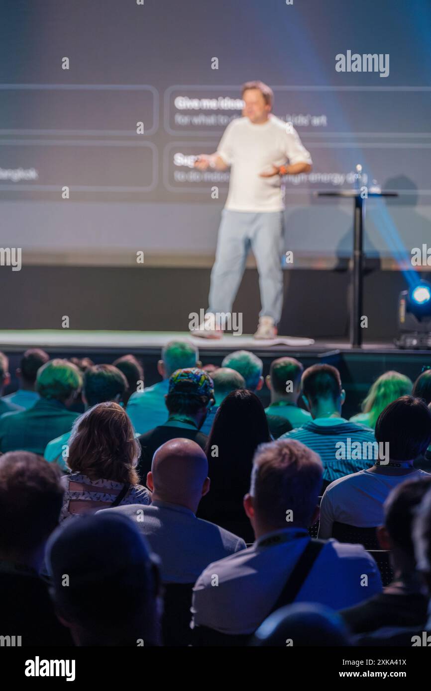 Speaker presenting at a conference, engaging audience with key points ...