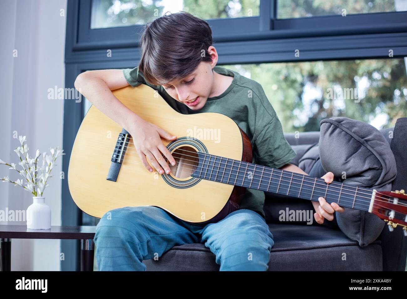 Cheerful boy playing the guitar Stock Photo - Alamy