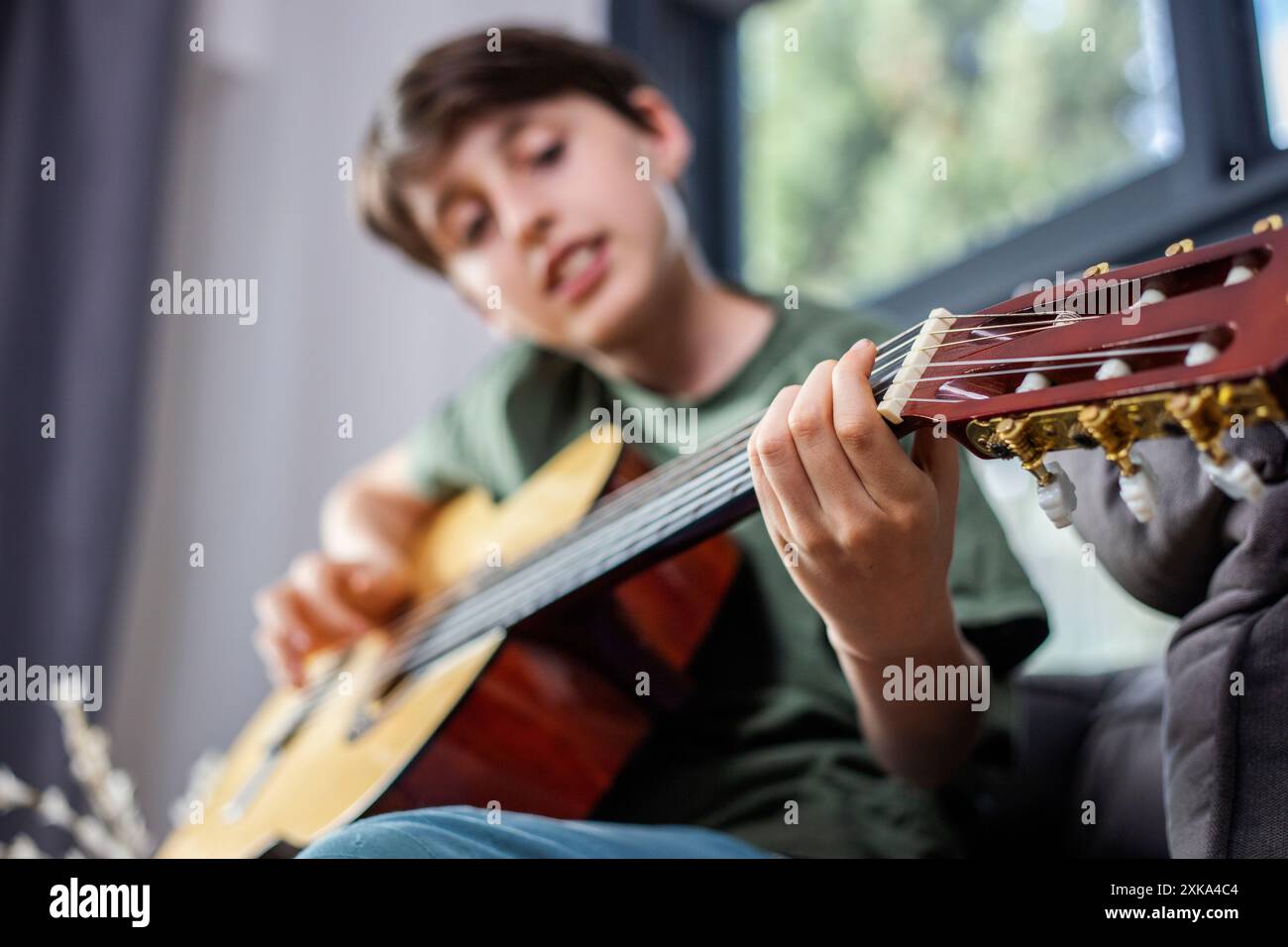 Cheerful boy playing the guitar Stock Photo - Alamy
