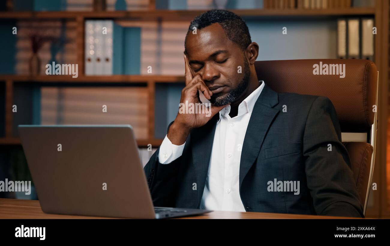 Tired sad businessman sitting in office sleepy exhausted african ...