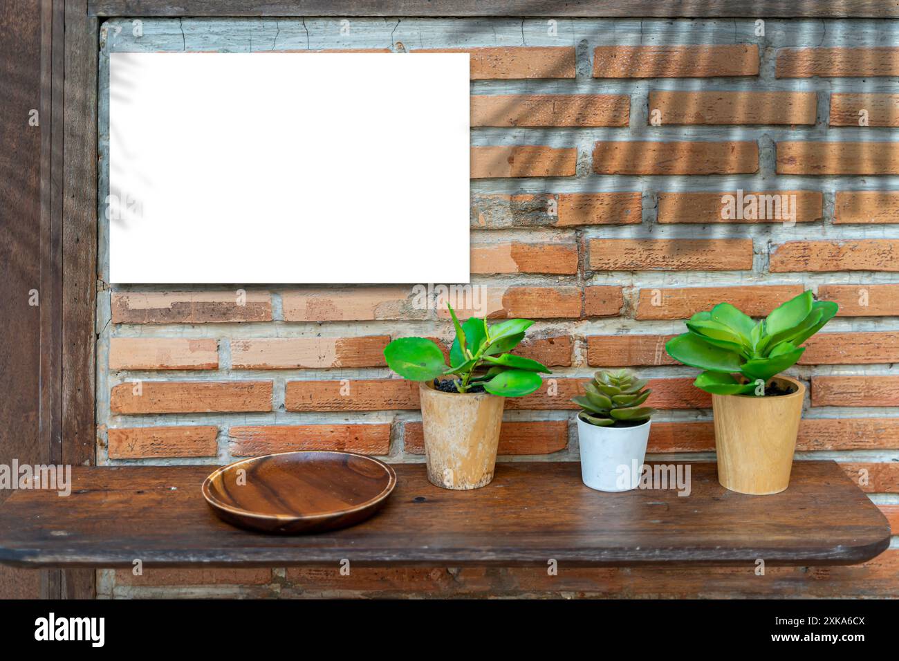 A white sign on a red brick wall is installed at the entrance of a ...