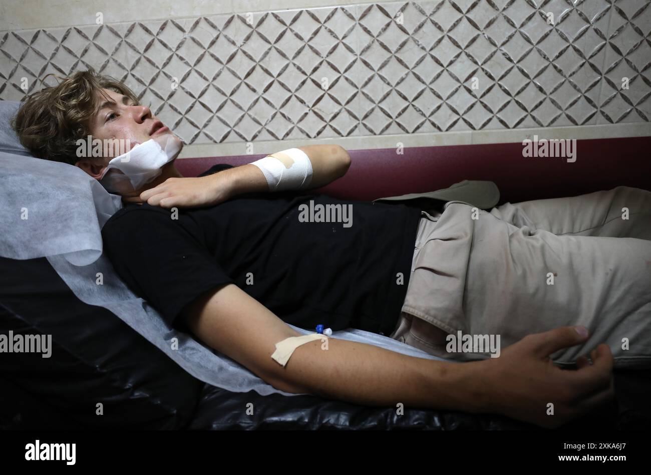 Nablus. 21st July, 2024. An injured foreign volunteer is seen at the ...