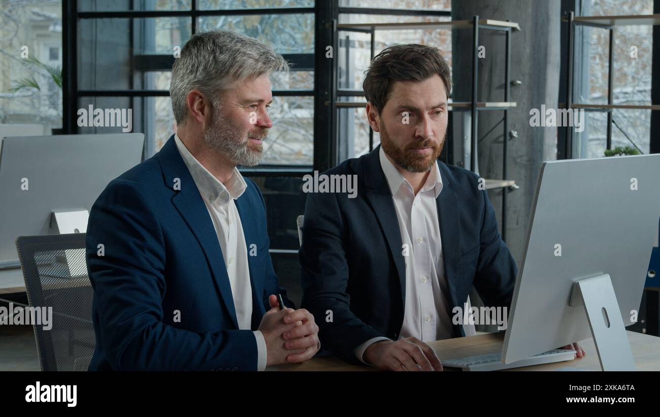 Two surprised happy Caucasian businessmen men business partner ...