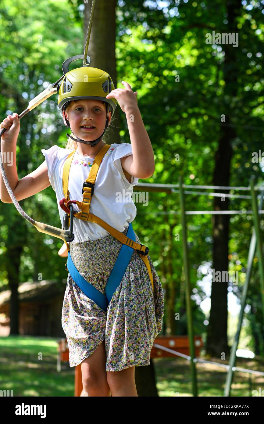Young adventurer navigating a treetop obstacle course, demonstrating ...