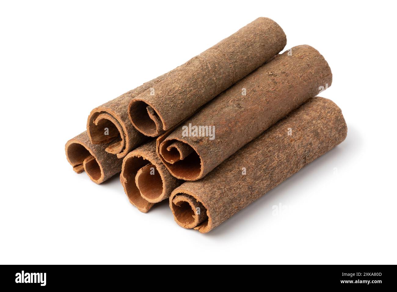 Heap of dried Chinese cassia cinnamon close up isolated on white ...