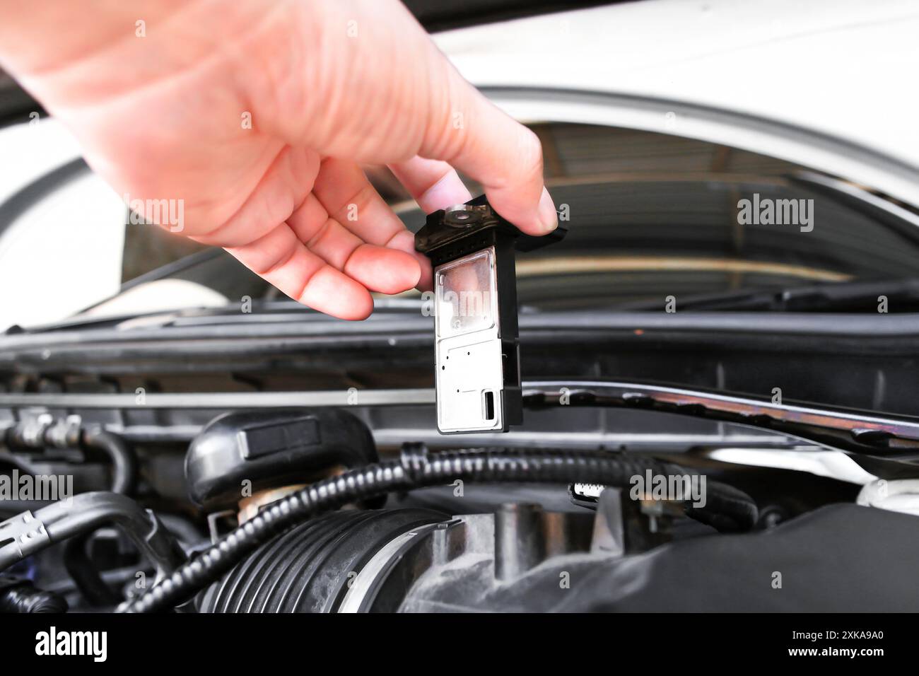 Mass air flow sensor in a hand of air intake manifold in the car engine ...