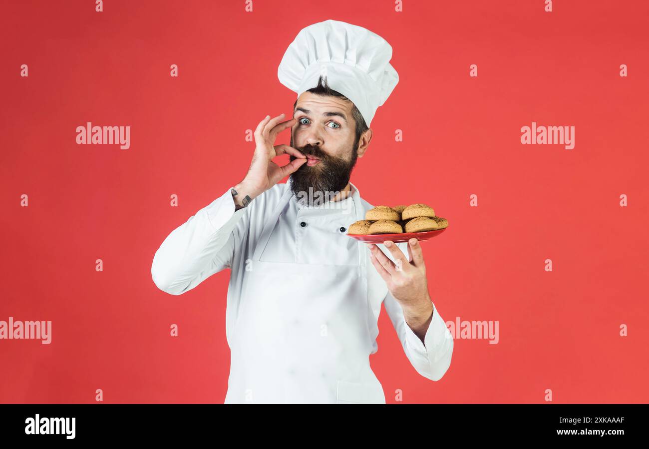 Smiling chef, cook or baker with taste approval gesture. Male chef with ...