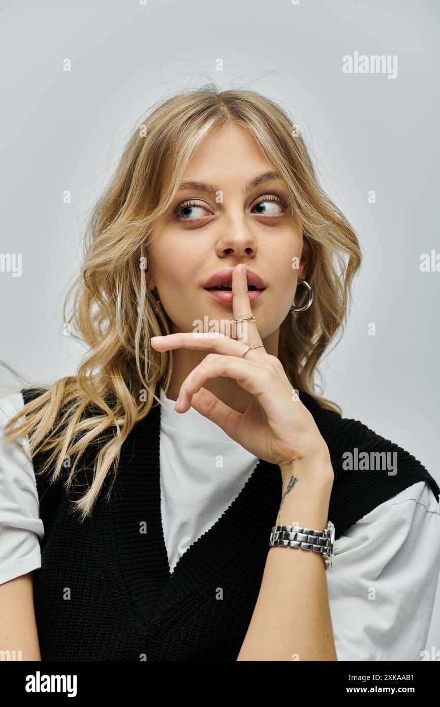 Young woman finger lips signaling hi-res stock photography and images ...