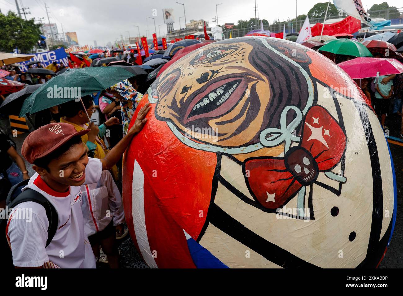 A demonstrator moves an effigy of Philippine President Ferdinand Marcos ...