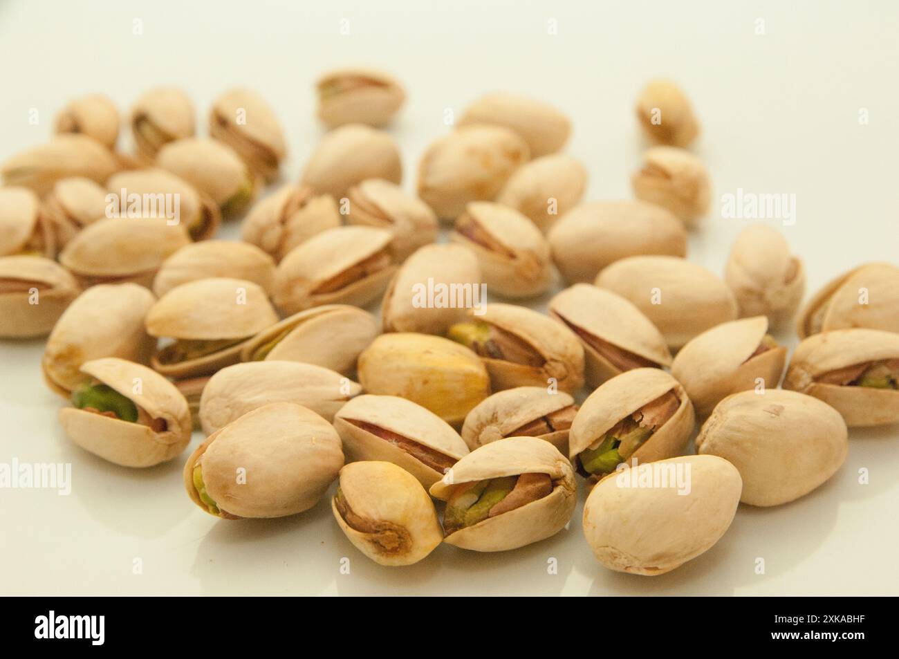 pistachios with a shell, on a white background Stock Photo - Alamy