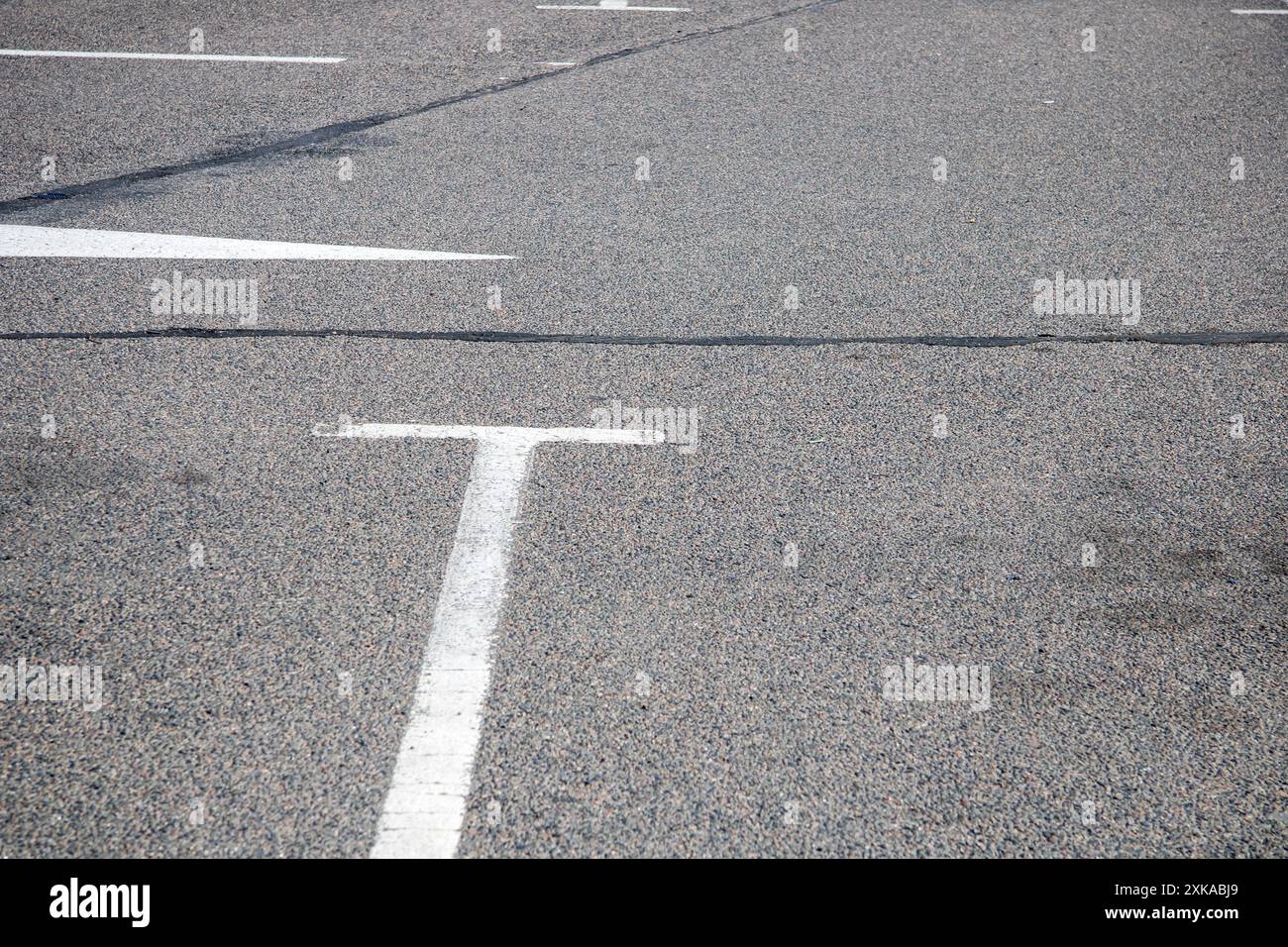 A close up view of a road showing a white line on the asphalt surface ...