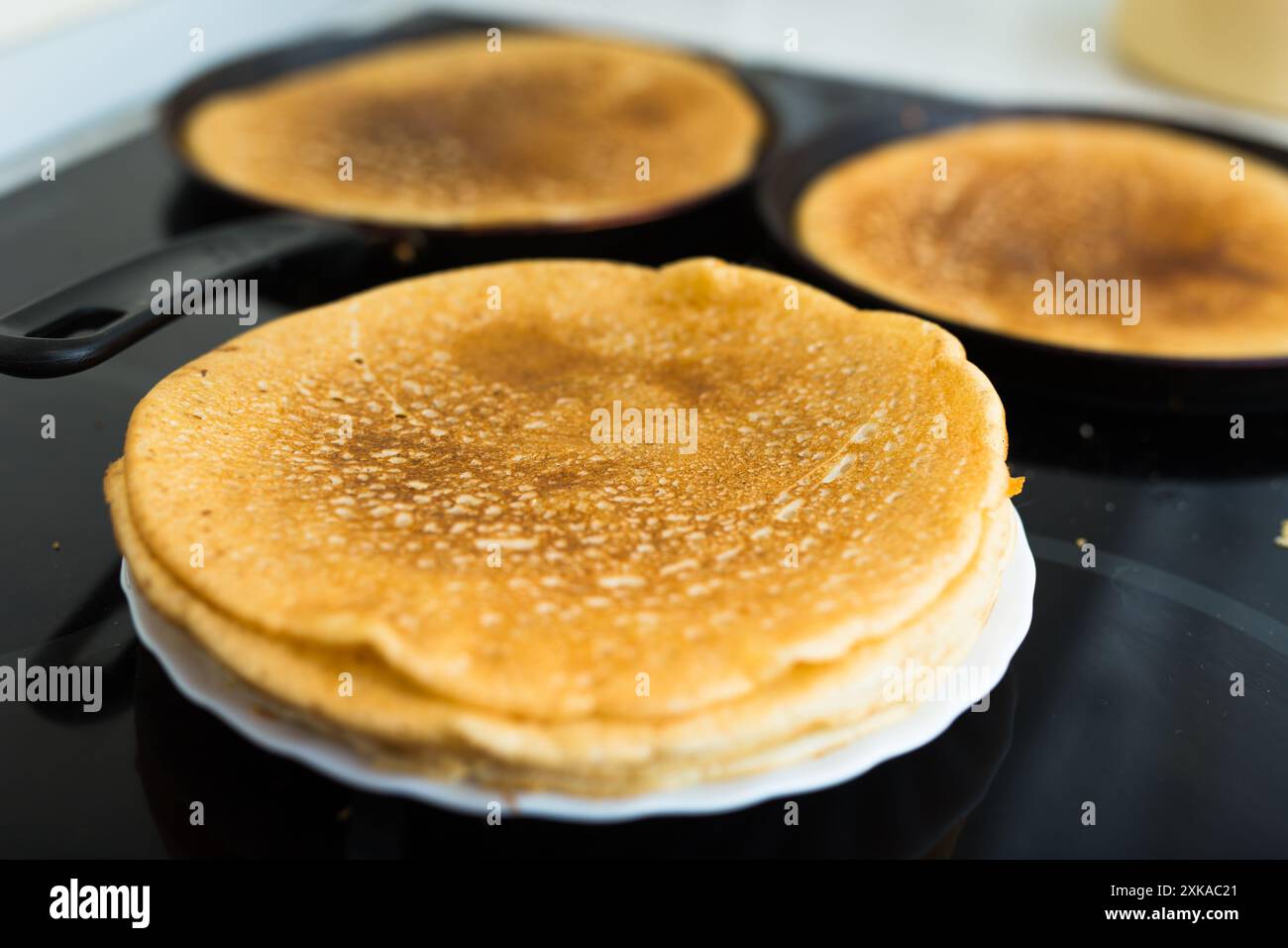 Cooking traditional pancakes from wheat flour in the kitchen Stock ...