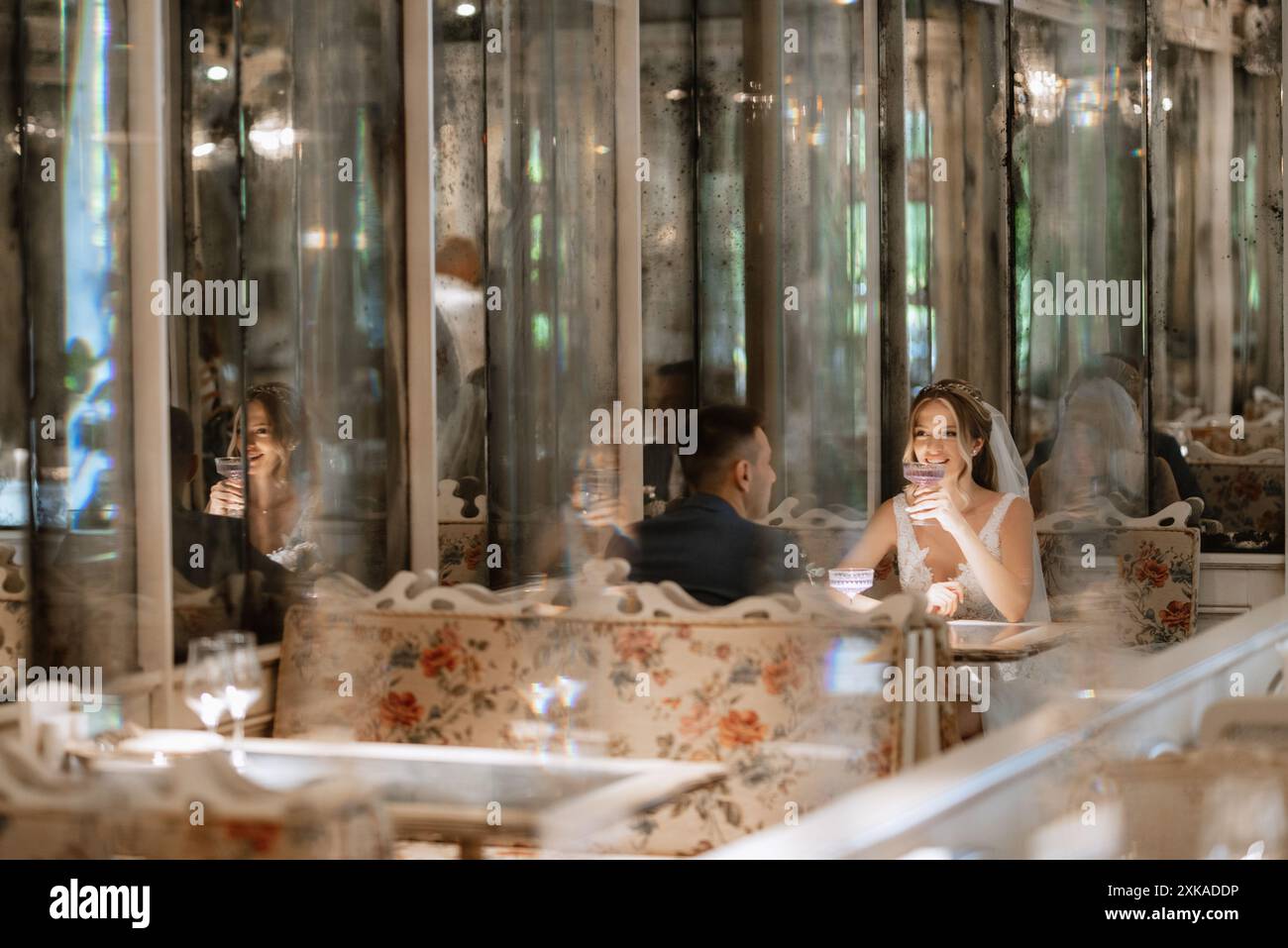 bride and groom inside a cocktail bar in a bright atmosphere with a ...