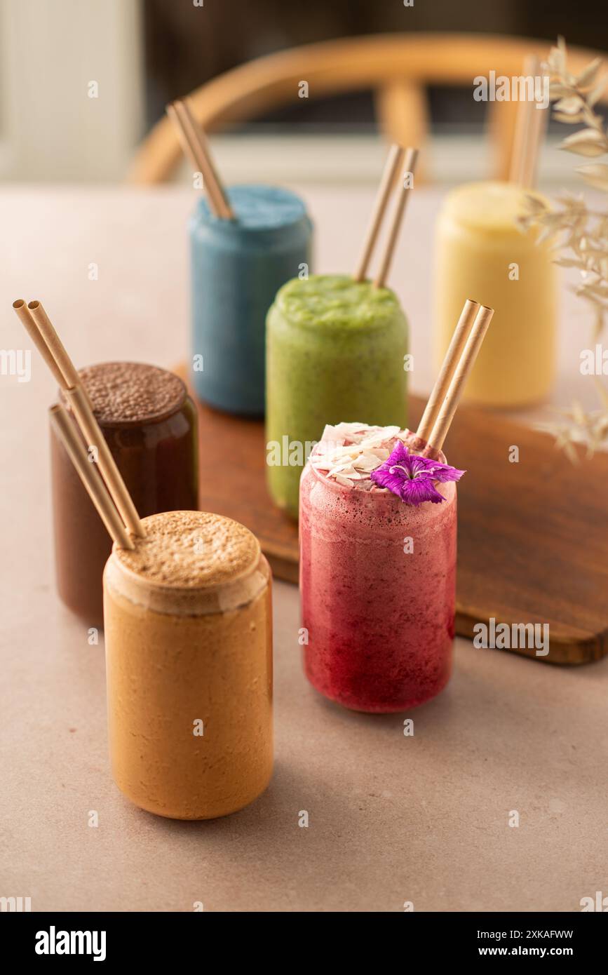 Selection of colourful smoothies beautifully decorated, on coffee shop ...