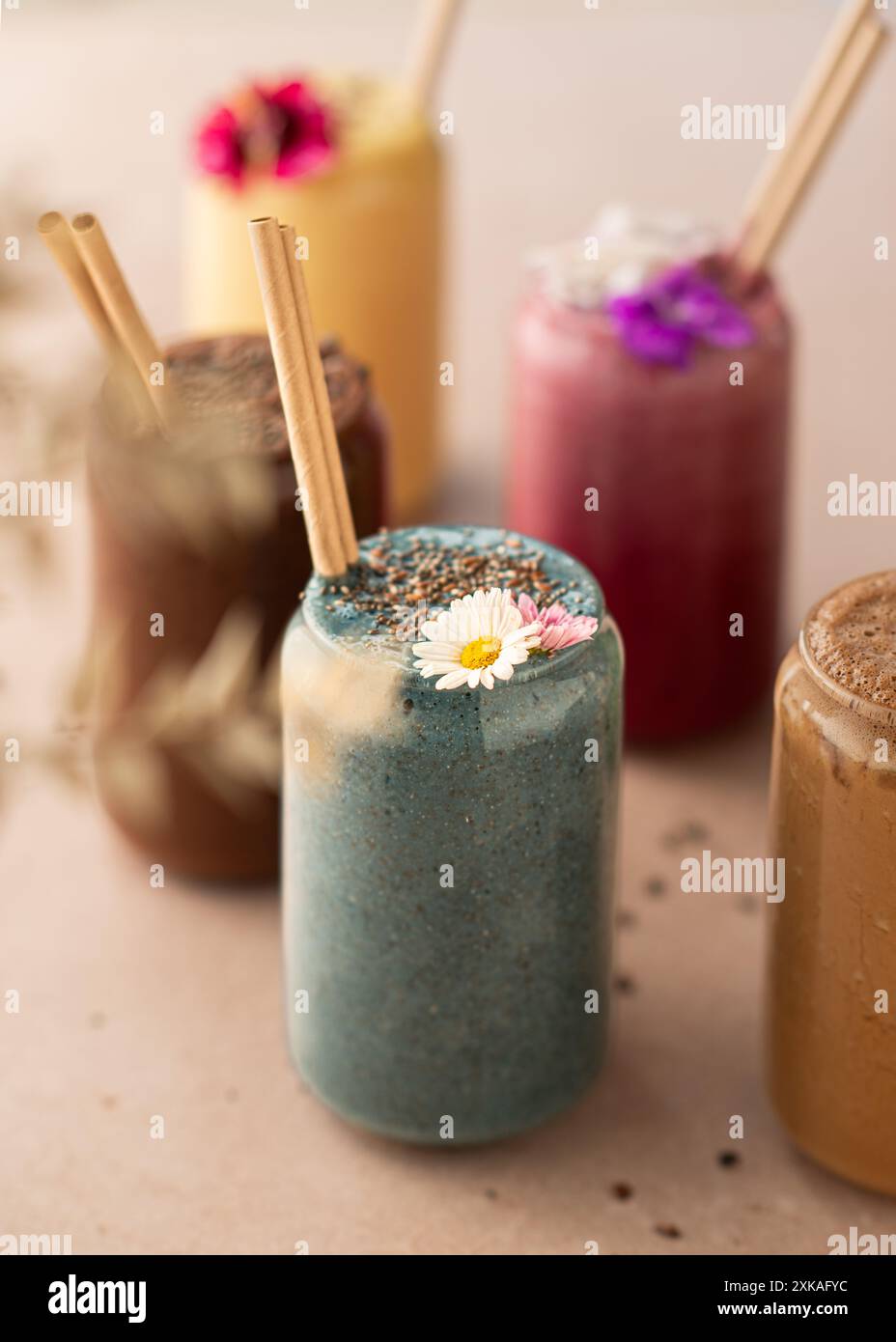 Selection of colourful smoothies beautifully decorated, on coffee shop ...