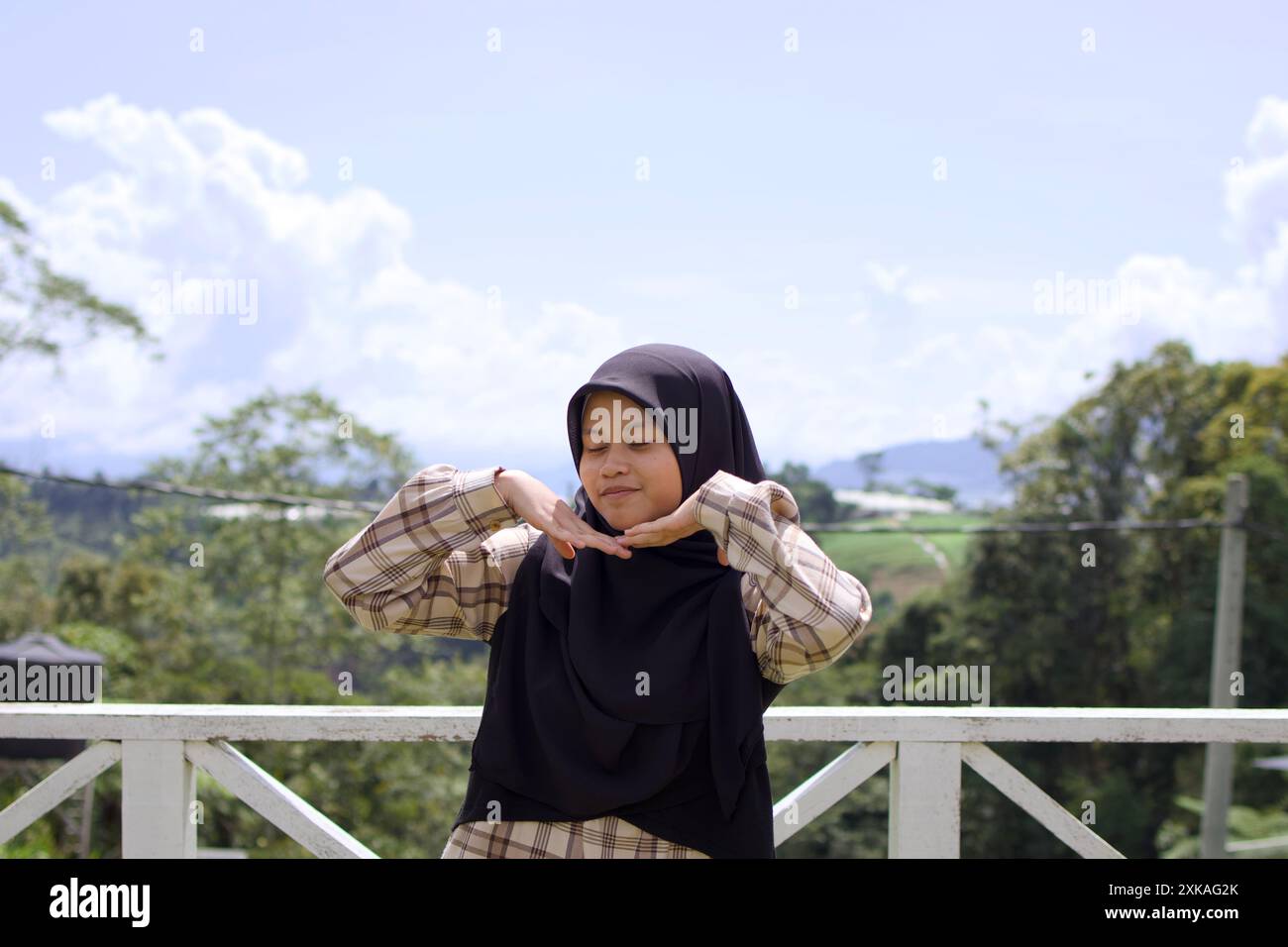 Kelantan, Malaysia - May 28 2024 : A young woman in a black hijab and ...
