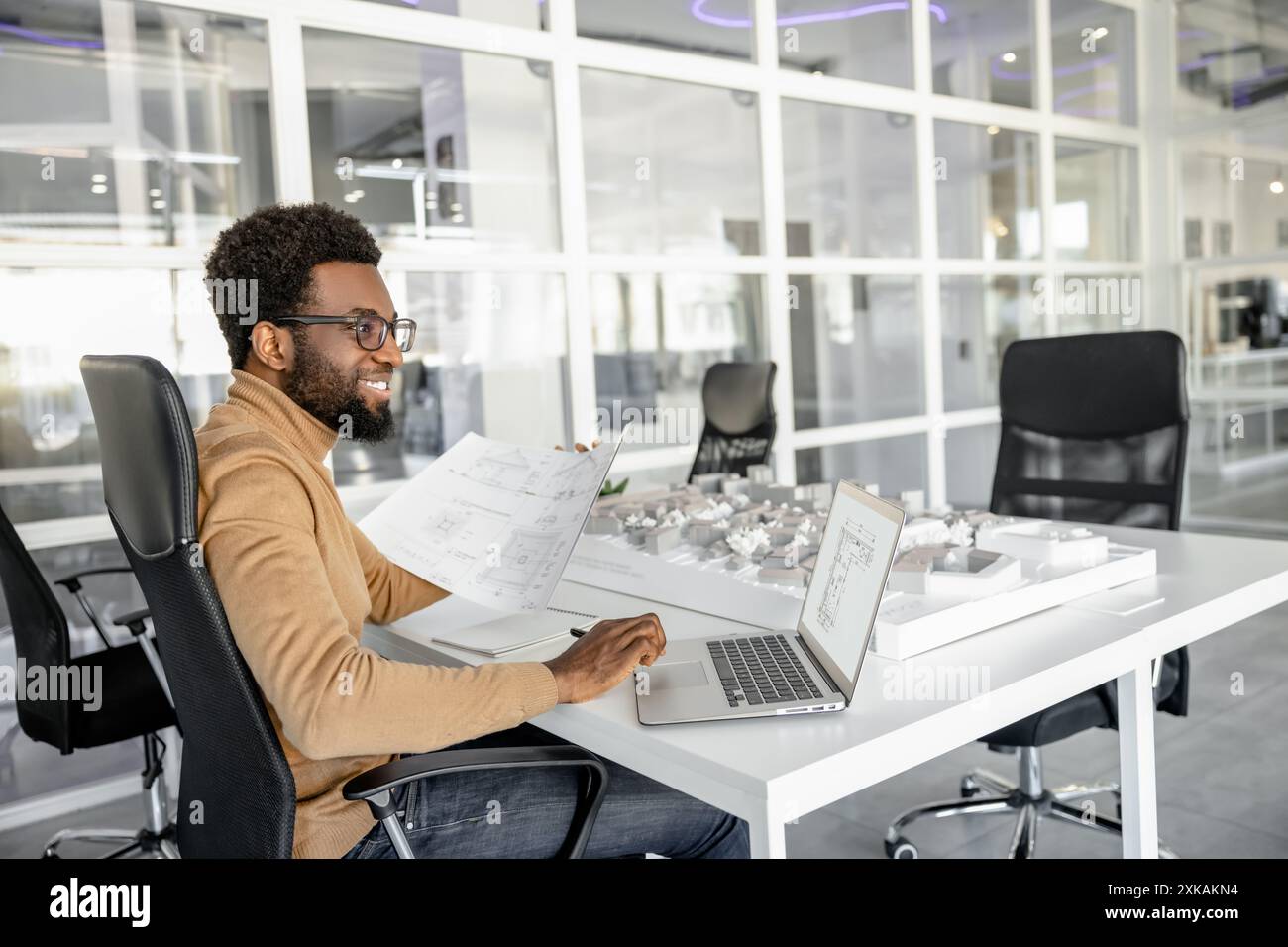 Professional man architect creating exterior designs in the workplace ...
