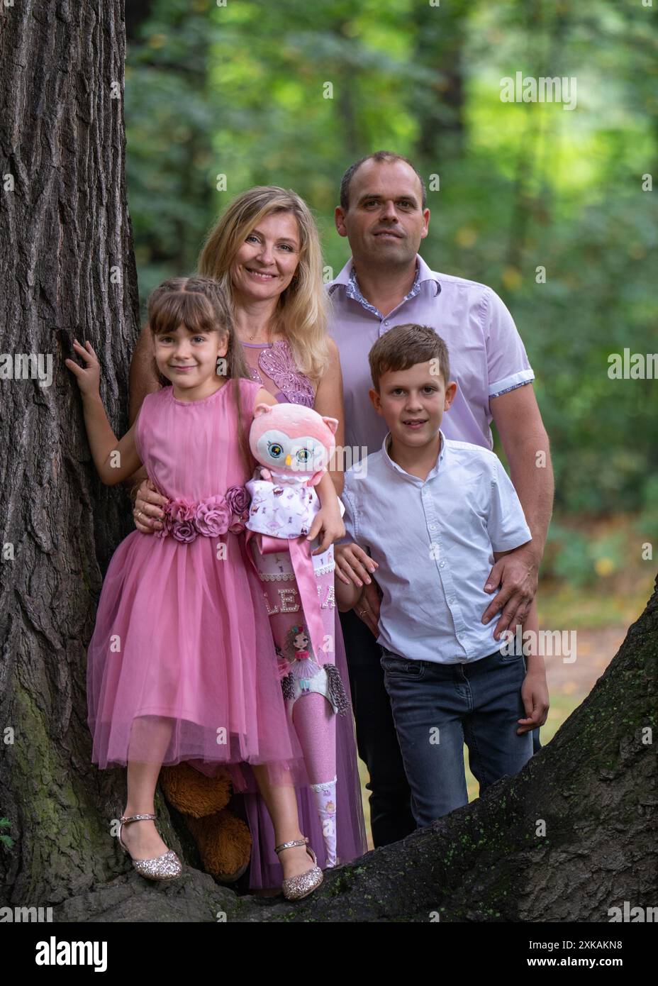 Portrait of a happy family. A laughing father and mother, a teenage son ...
