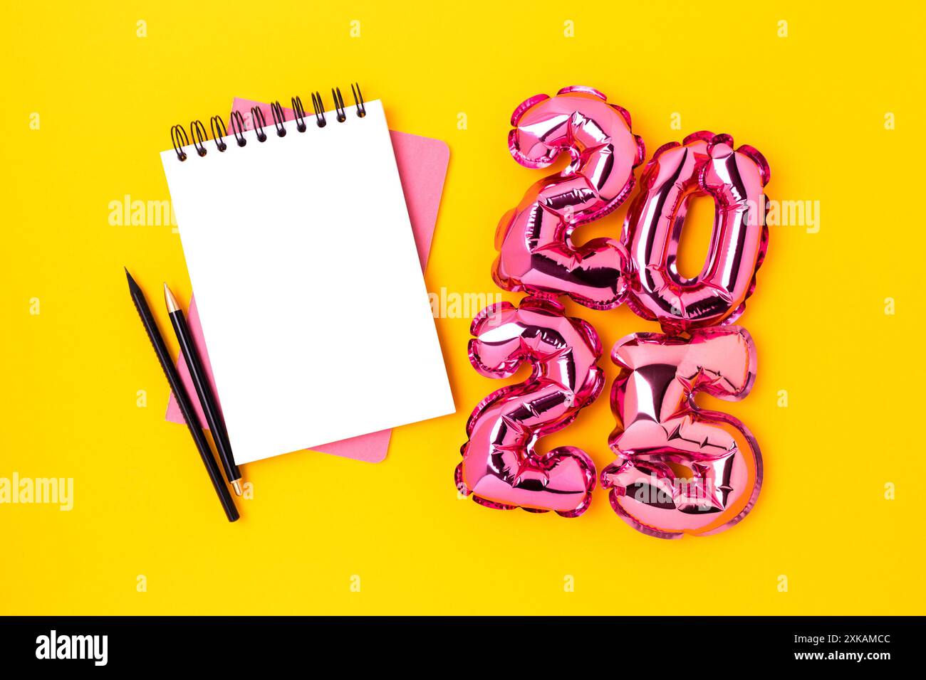 2025 New Year concept. Blank notepad mockup and pink numbers balloons ...