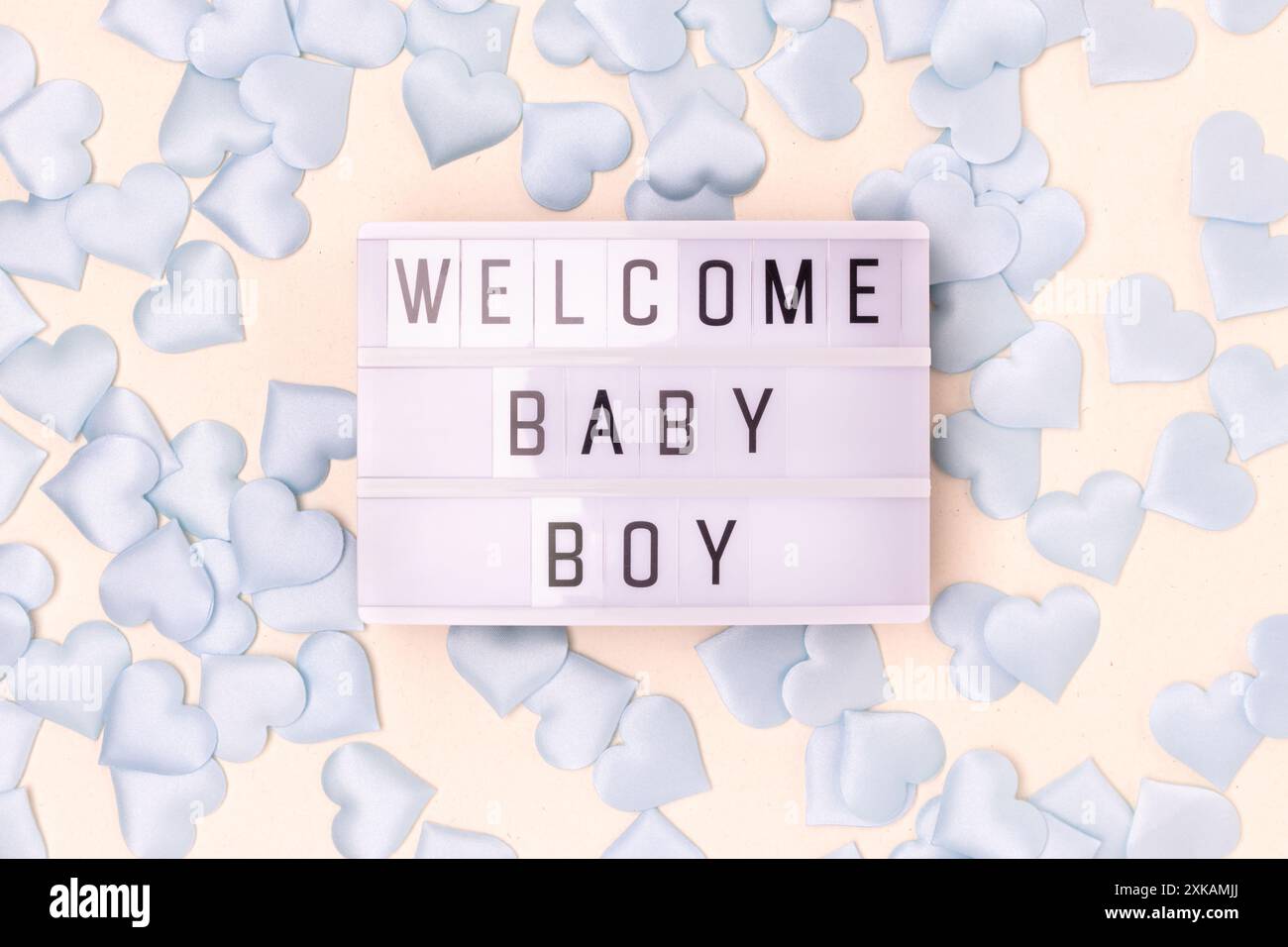Welcome baby boy. Lightbox with letters and blue confetti in a heart ...