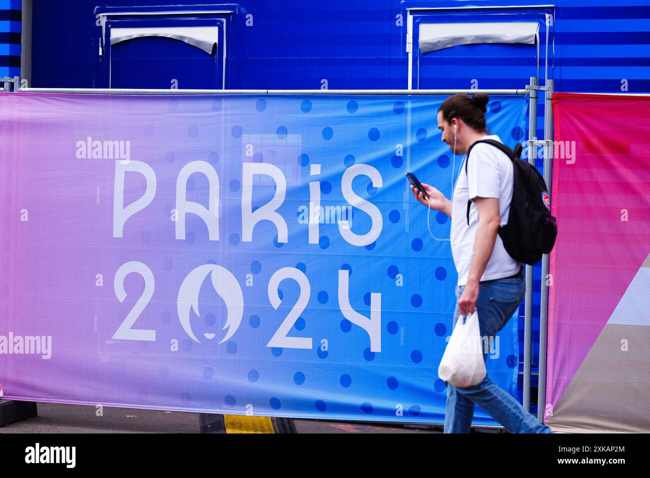 A person walks past Paris 2024 signage in Paris. The Opening Ceremony ...
